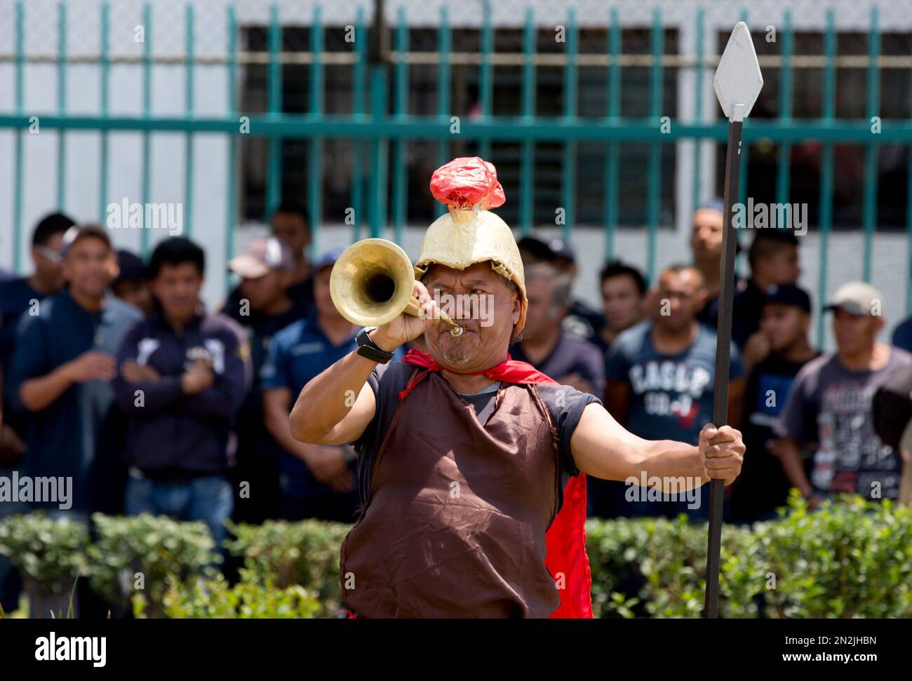 An inmate playing a trumpet wears a handmade Roman soldier helmet, made ...