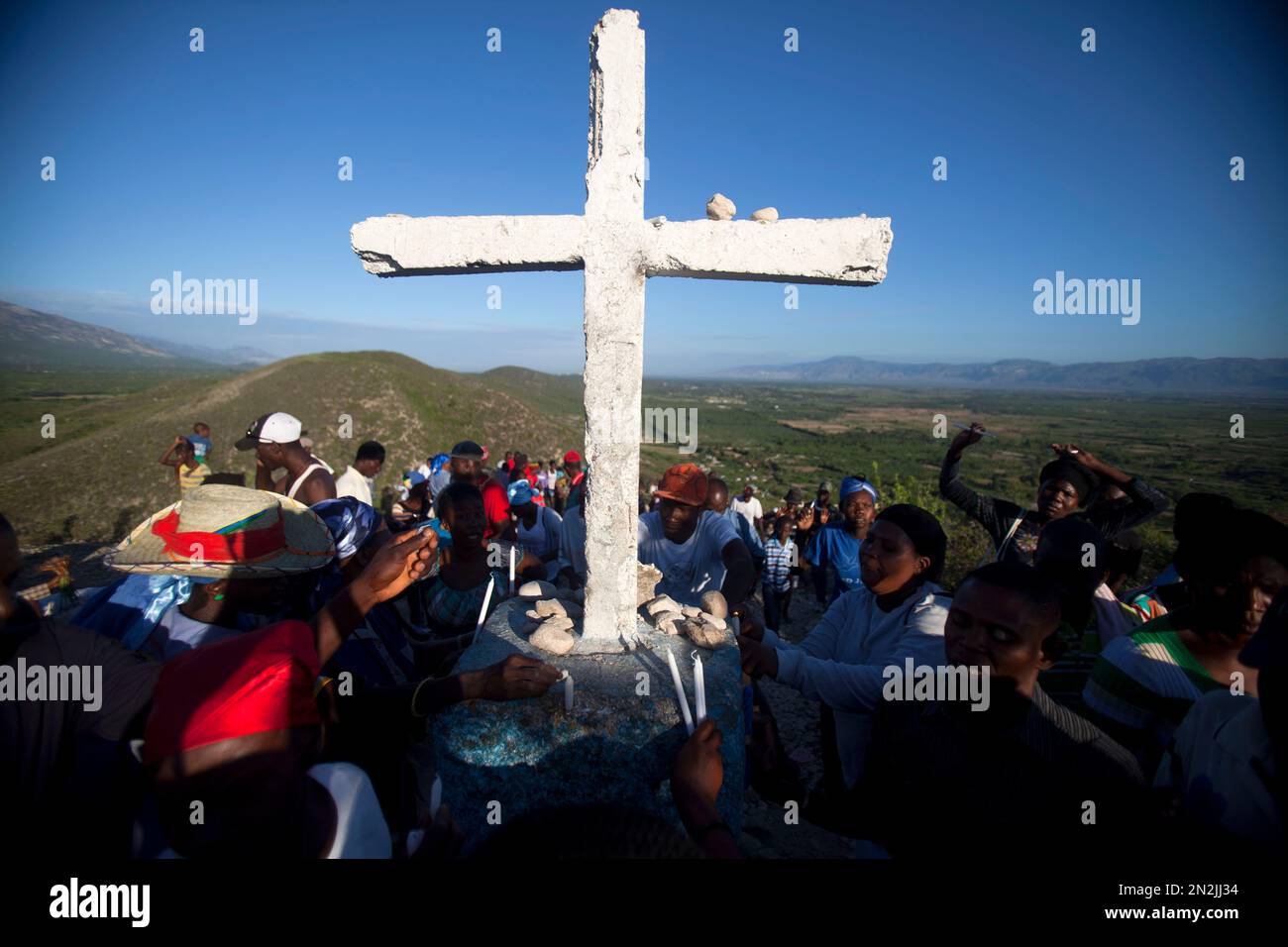 Pilgrims kneel in prayer after reaching the final of the 14 Stations of ...