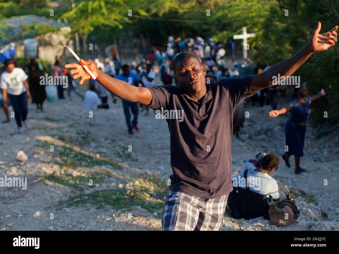A man prays with arms outstretched during a Good Friday pilgrimage to ...