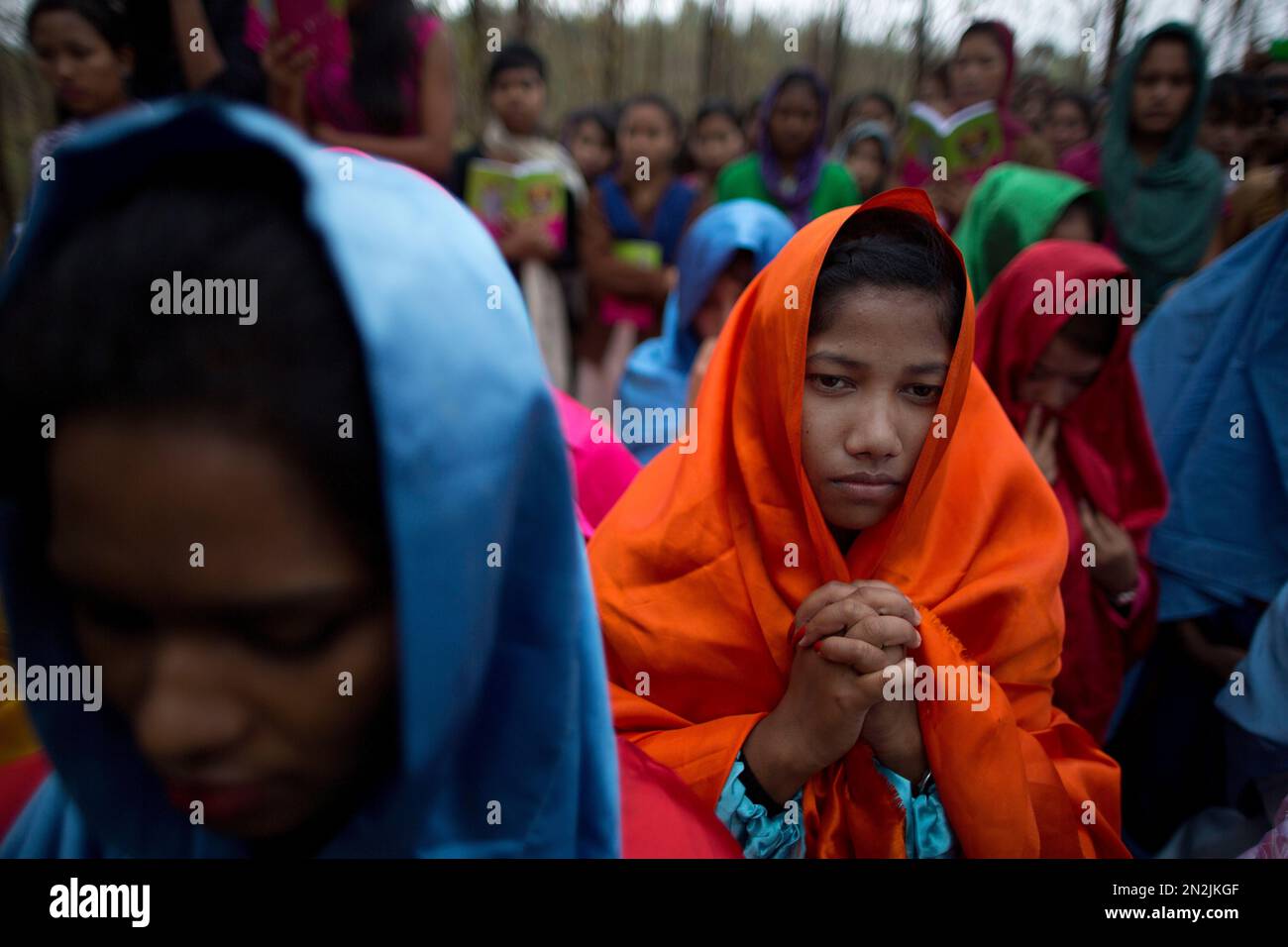 Indian Christian devotees pray as a man dressed as Jesus Christ, unseen ...