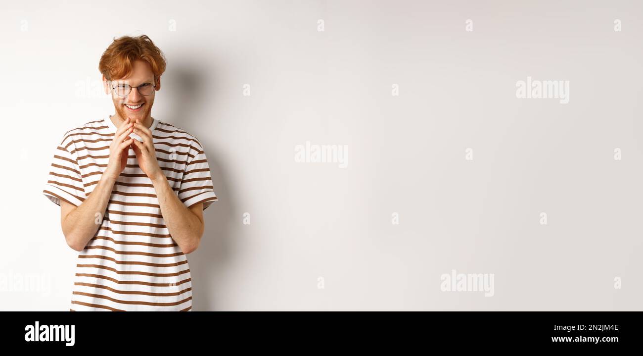 Portrait of redhead man looking like evil genius, steeple fingers and ...