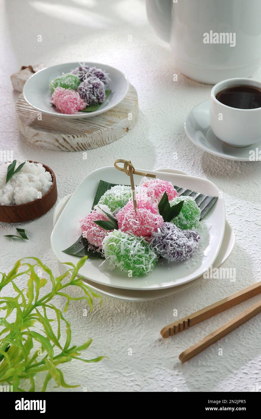 serving of steamed cenil cake with grated coconut and a cup of coffee ...
