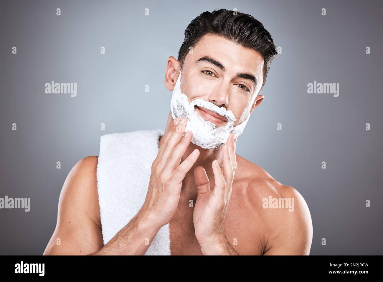 Portrait, shave cream and grooming with a man model in studio on a gray background for hair ...