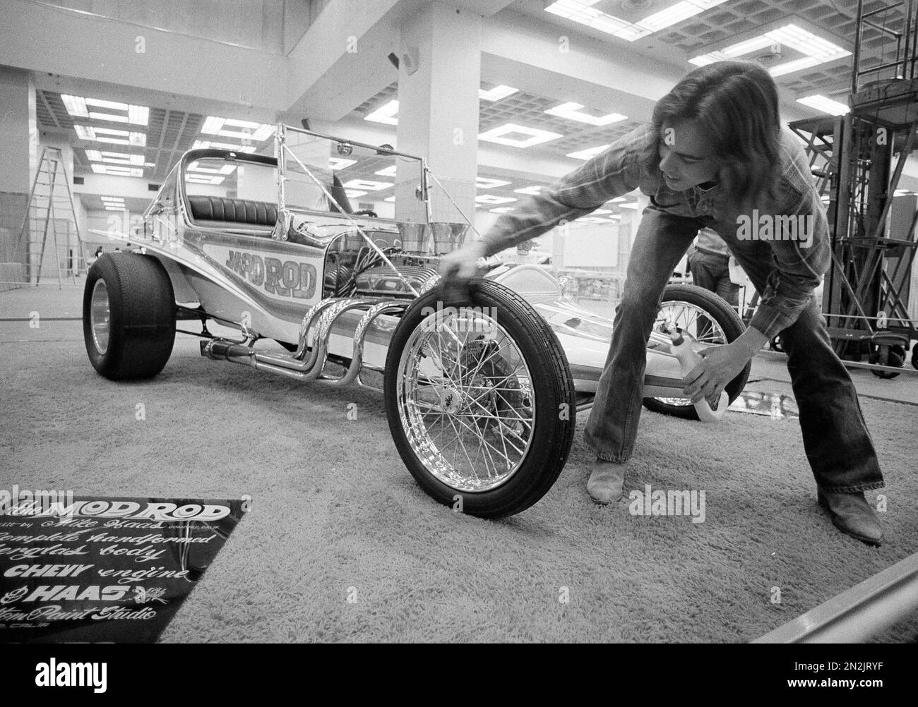 A workman polishes the Mod Rod, one of the customized autos shown Feb ...