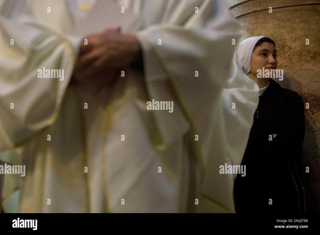 A nuns stands during the Washing of the Feet ceremony at the Church of ...