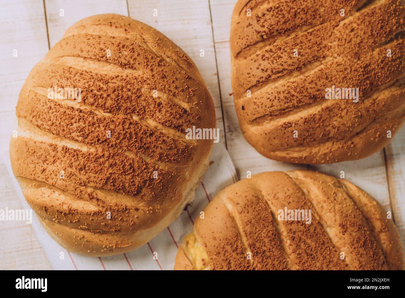 A top view of freshly baked crusty bread put on the white table Stock ...