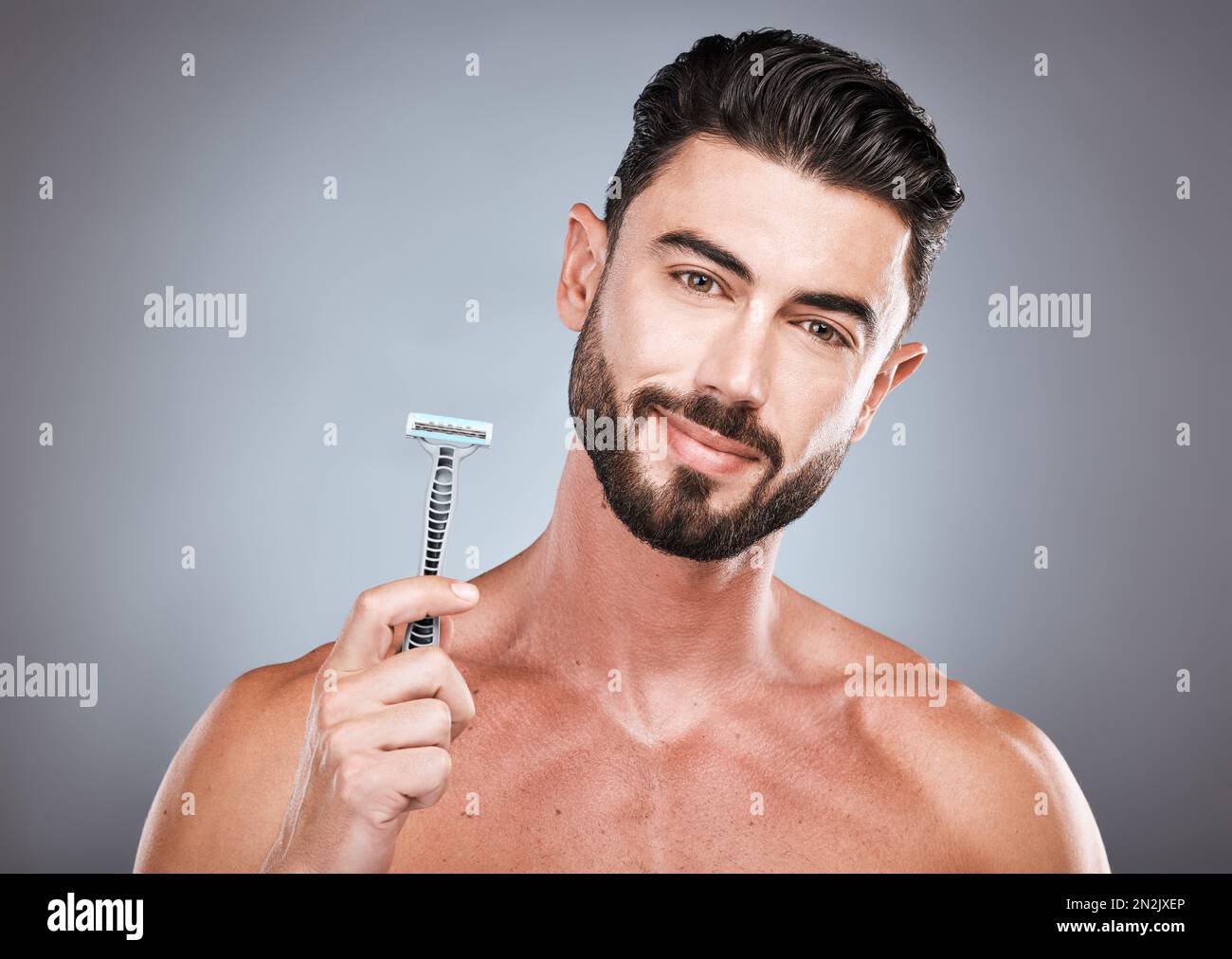 Face, portrait and man with razor in studio isolated on a gray background for shaving. Skincare ...