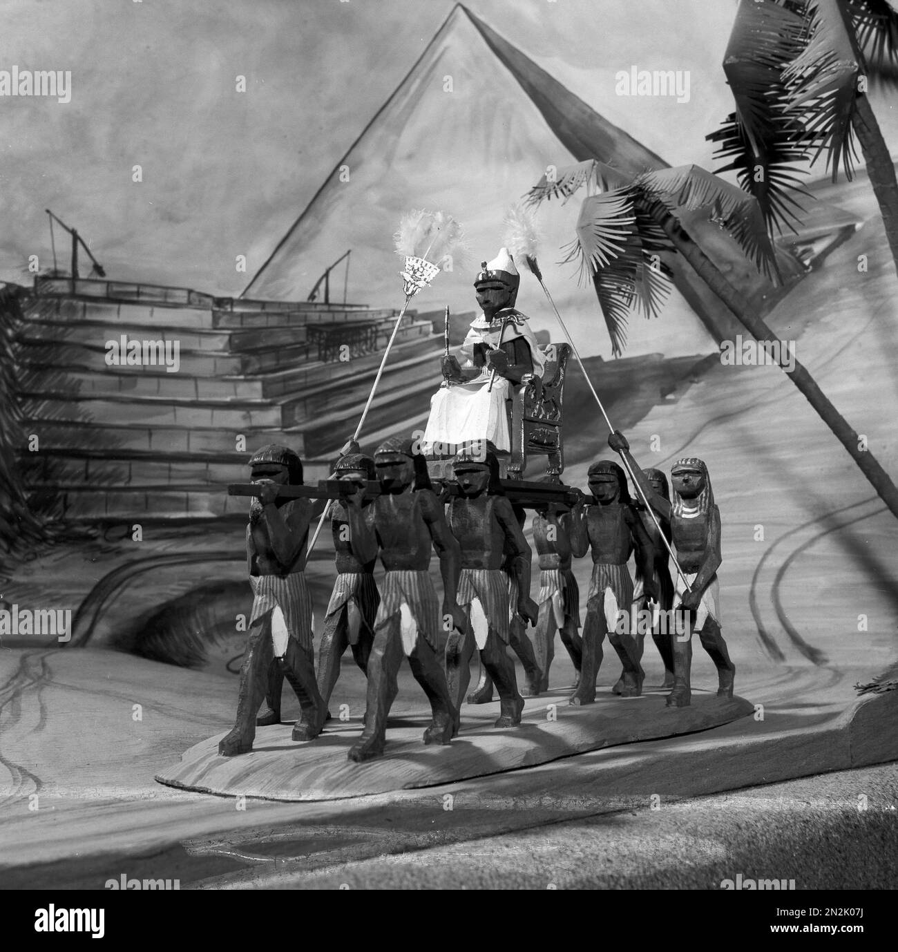 A model of the ancient Egyptian king, Ramses II, carried by slaves, is ...