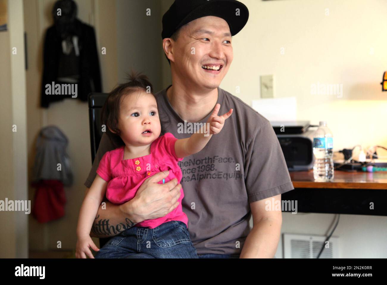 Korean adoptee Adam Crapser poses with daughter, Christal, 1, in the ...