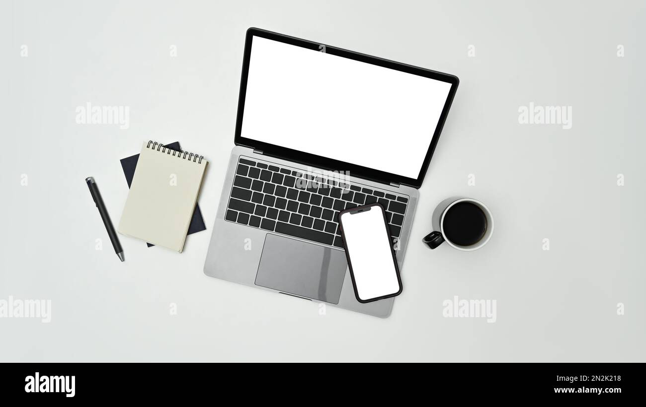 Above view laptop computer, smart phone, notepad and coffee cup on ...