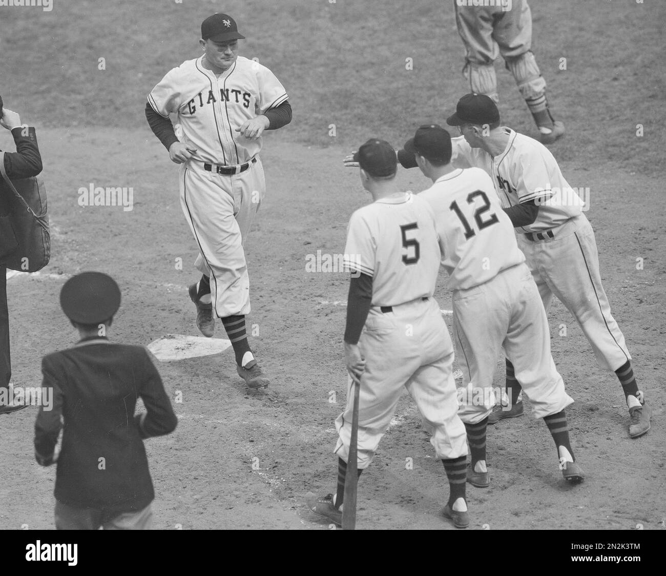 Three New York Giants players line up to greet Giants' first baseman ...