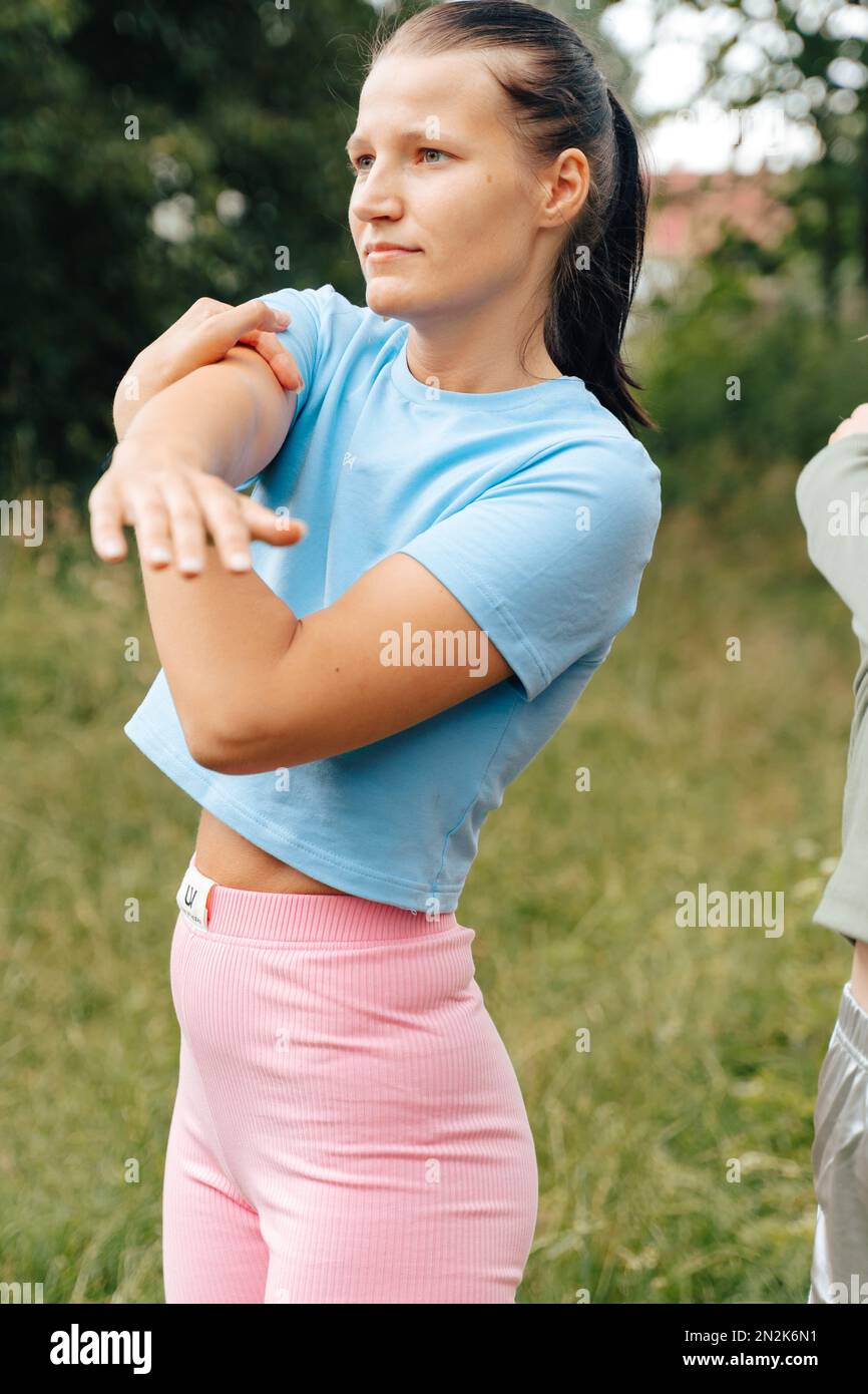 Millennial Woman doing Exercises On nature. Beautiful Athletic teen ...