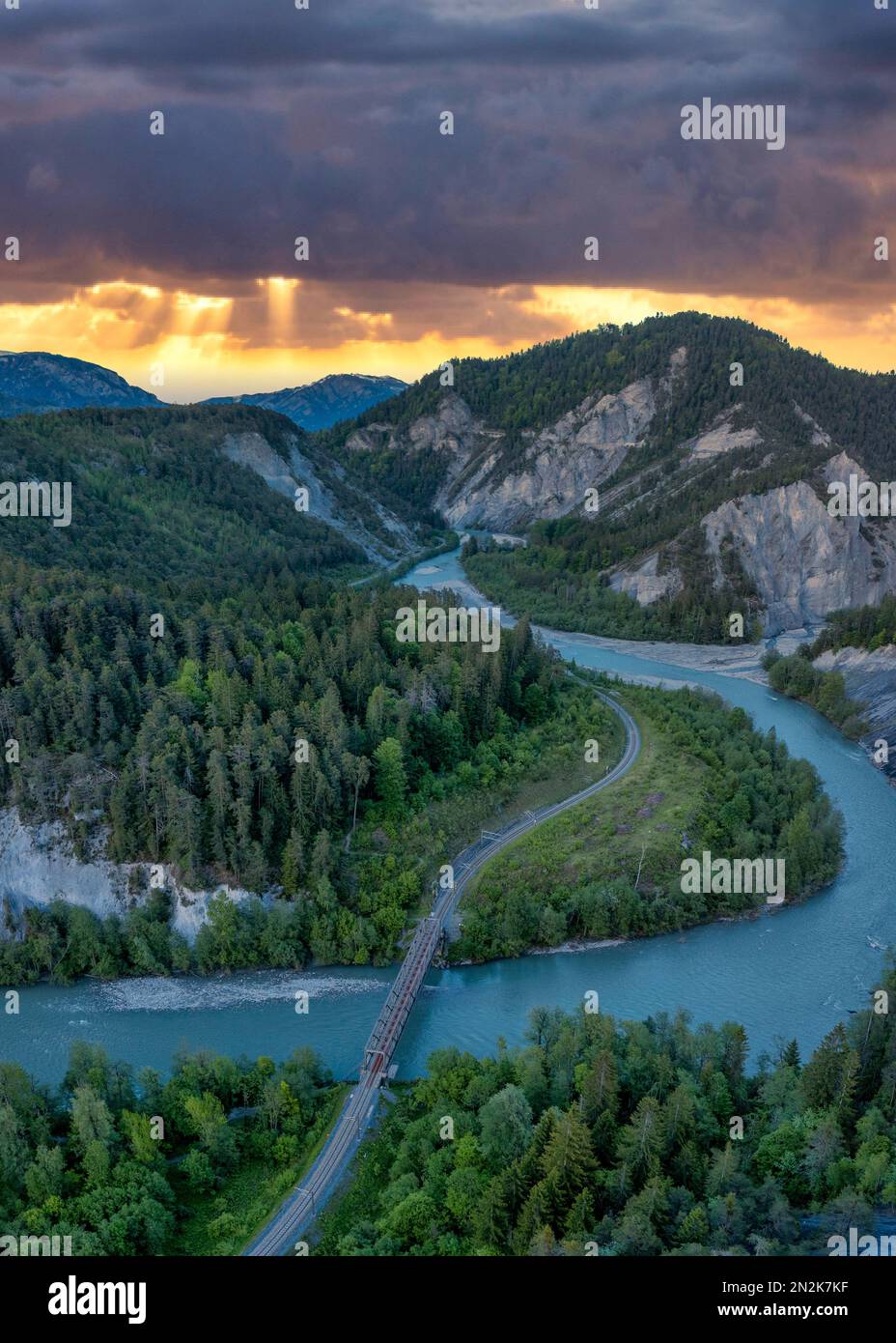 A river that runs in a S curve between the mountains,a railroad bridge ... A river that runs in a S curve between the mountains,a railroad bridge ...
