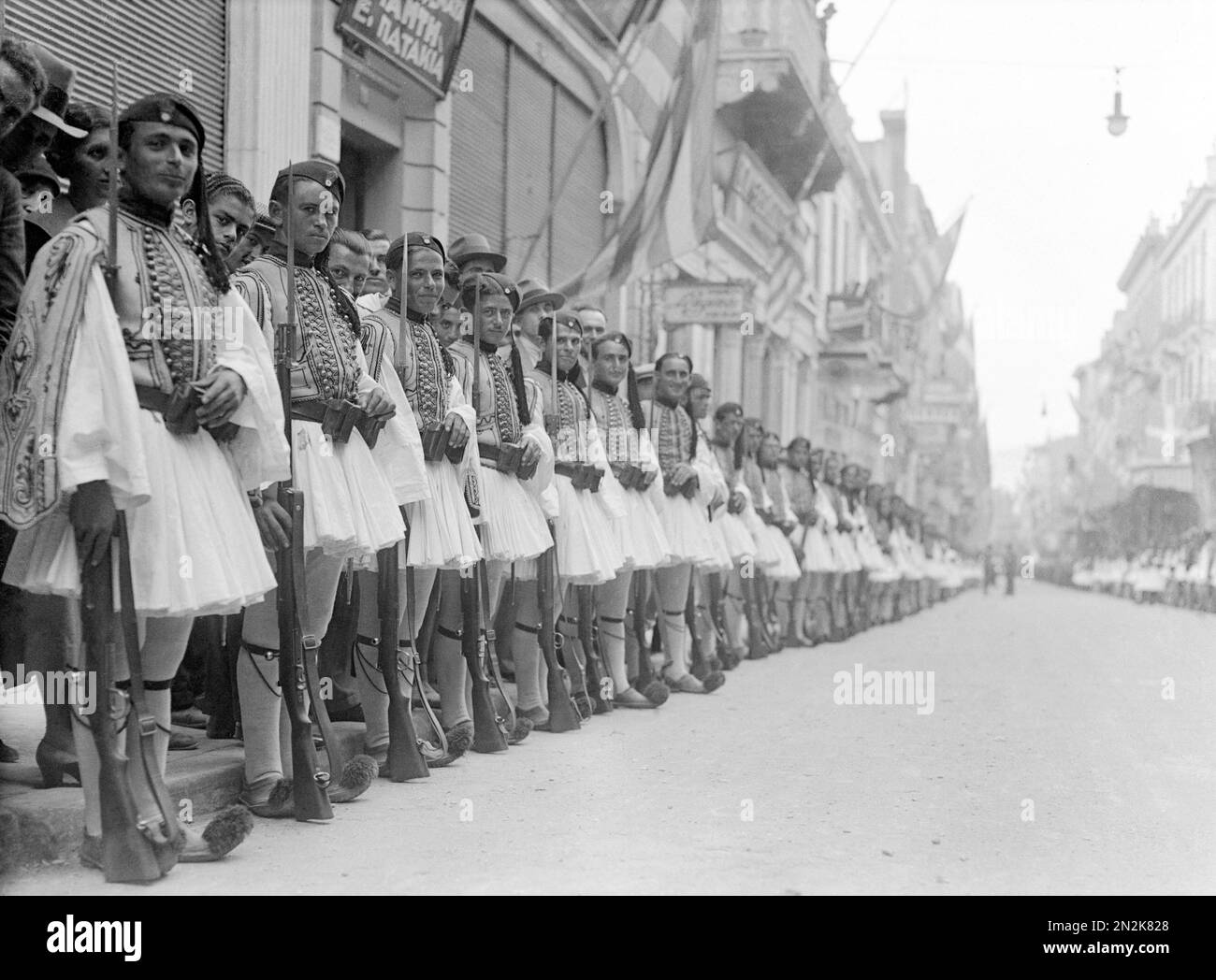 Evzones, the Greek Royal Guards, lined up in the streets of Athens ...