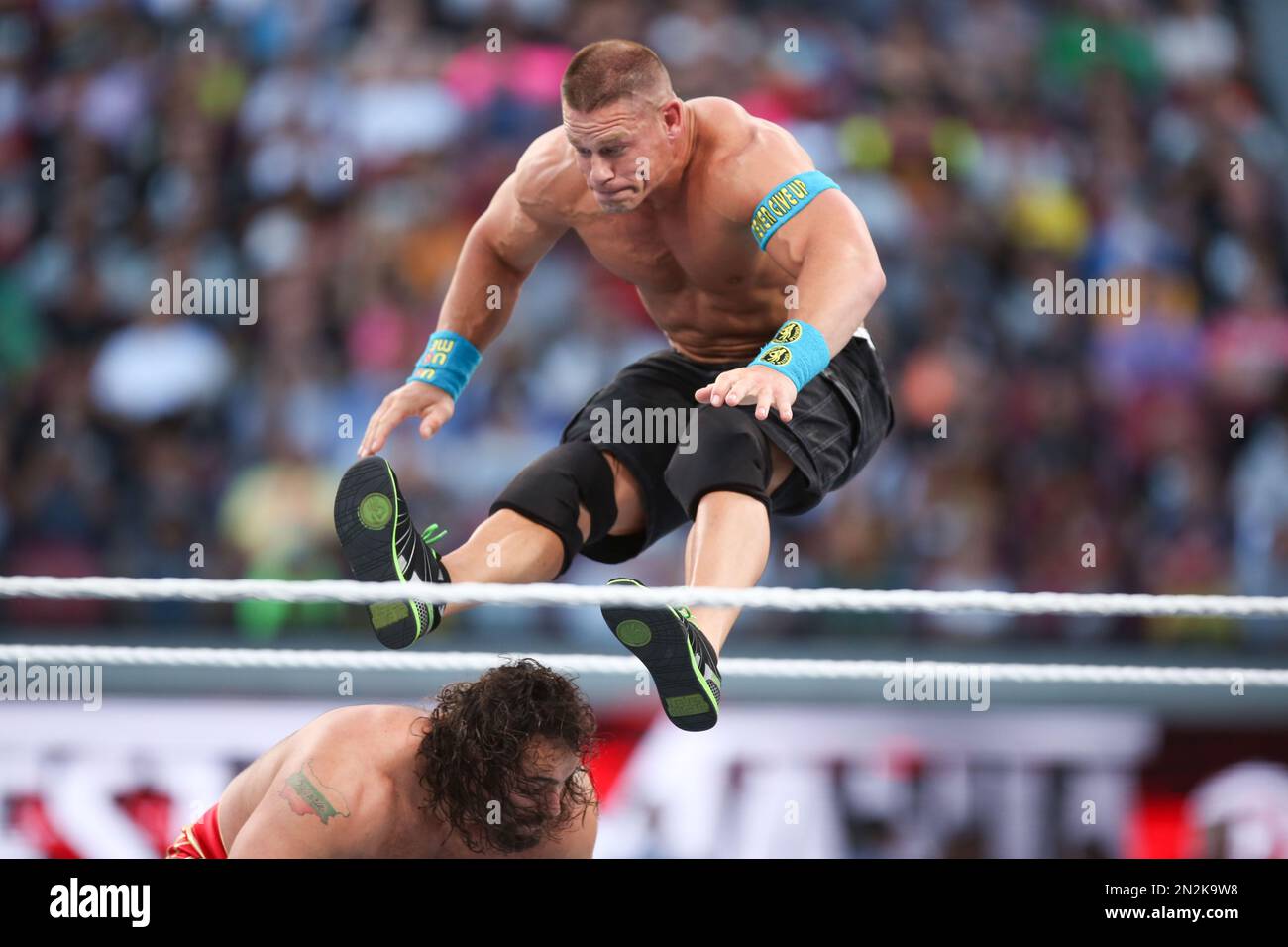 WWE wrestler John Cena lands on opponent Rusev at Wrestlemania XXXI, on ...