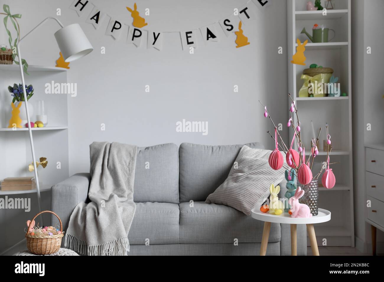 Interior of living room with Easter eggs, tree branches and rabbits ...