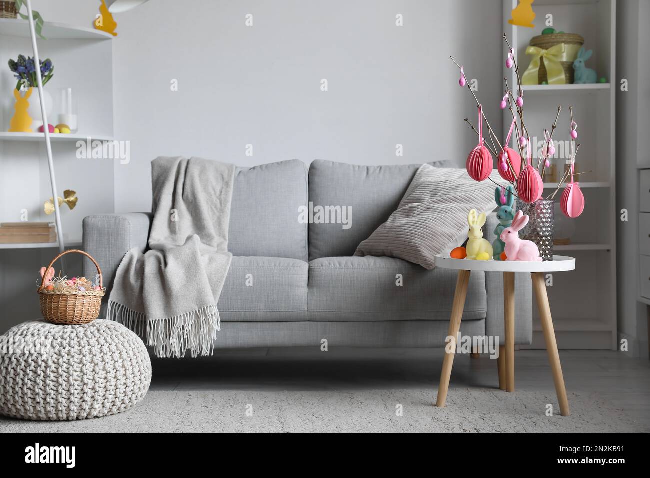 Interior of living room with Easter eggs, tree branches and rabbits ...