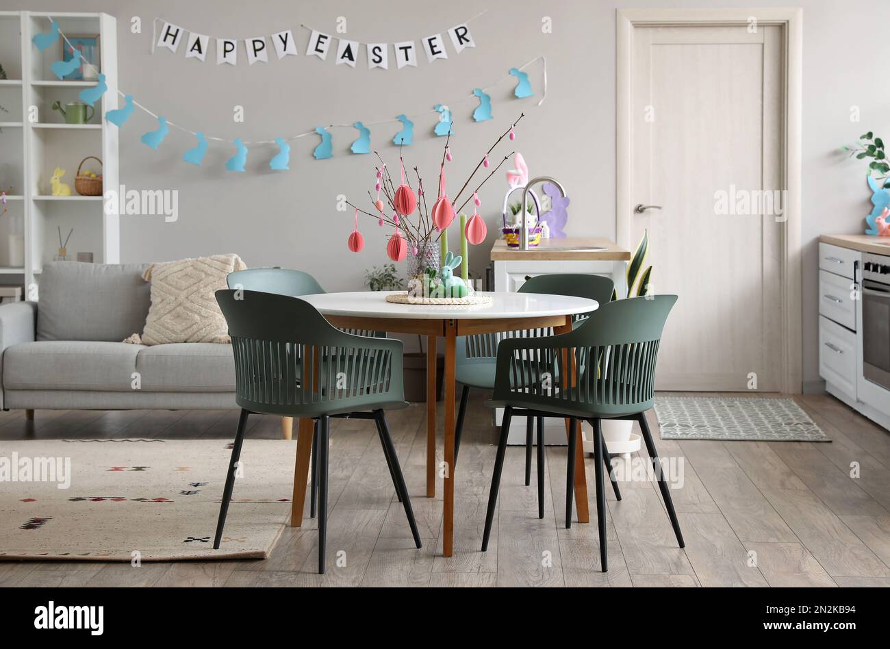 Interior of kitchen with tree branches, Easter eggs and dining table ...