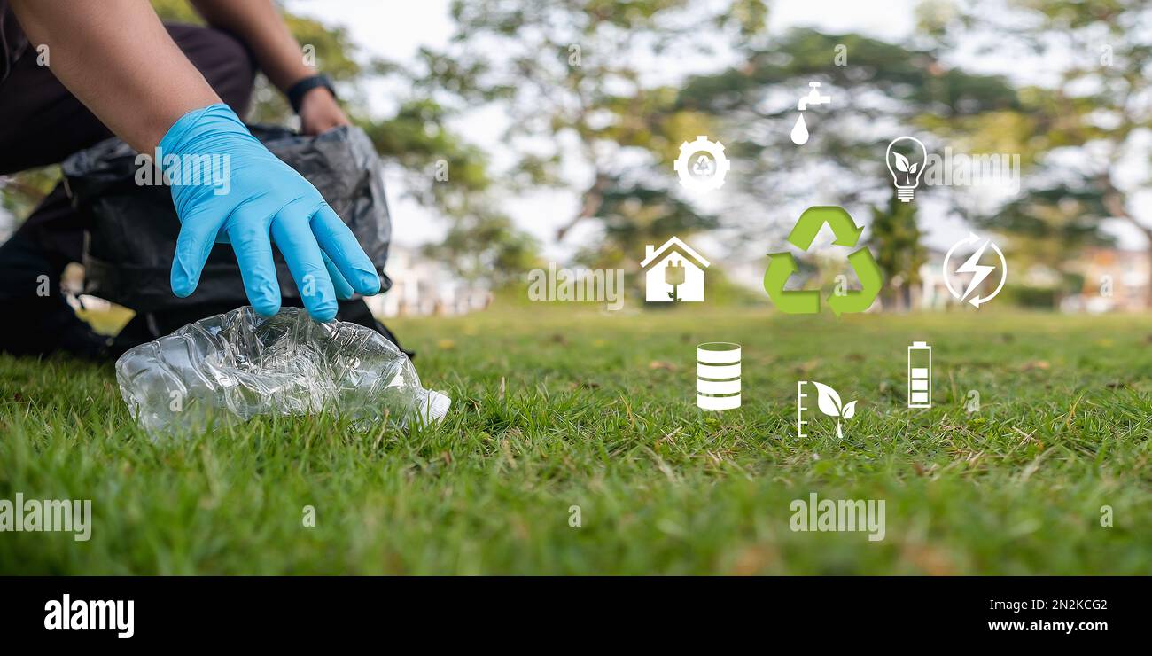 Volunteer man collecting trash and reusing plastic cleanup to recycle ...