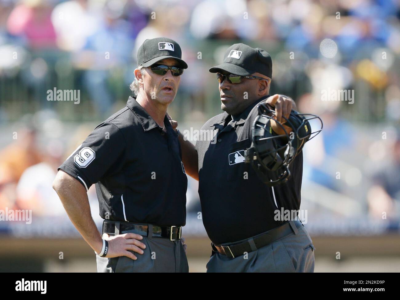 Umpires Paul Nauert, left, and Laz Diaz talk during the sixth inning of a spring training ...