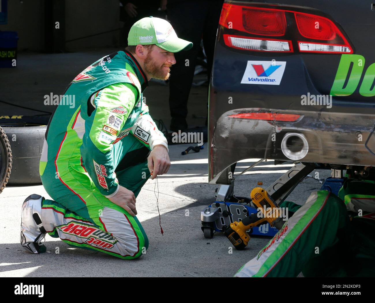 Dale Earnhardt Jr. looks over his car after it was damaged in a wreck ...