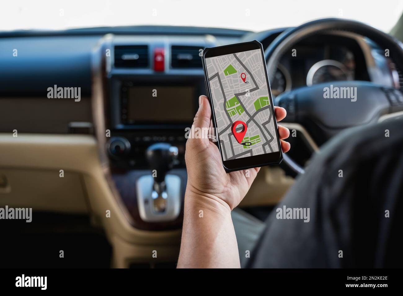 A man makes use of GPS and the internet. online map in the car controls ...