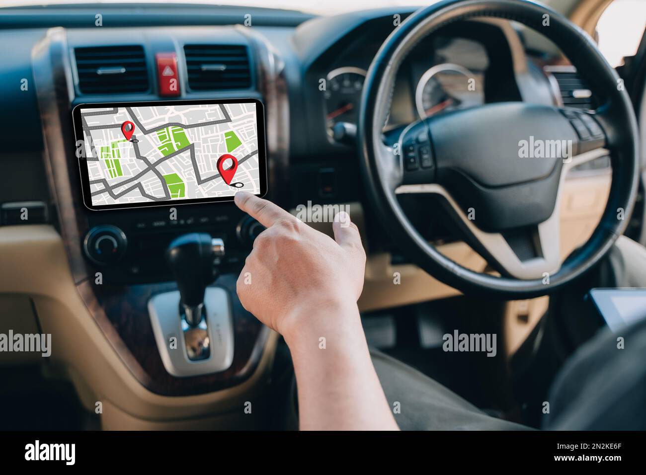 A man makes use of GPS and the internet. online map in the car controls ...