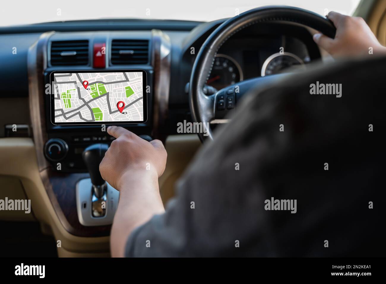 A man makes use of GPS and the internet. online map in the car controls ...