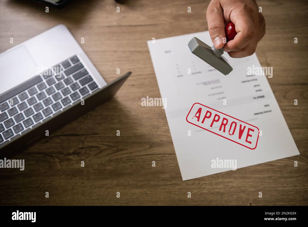 man stamping approval Text is approved by stamping the document on ...