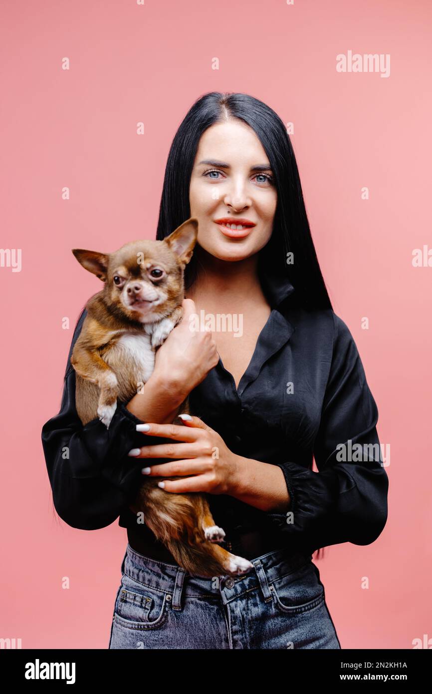 Wonderful european female model chilling in studio with puppy. Indoor ...