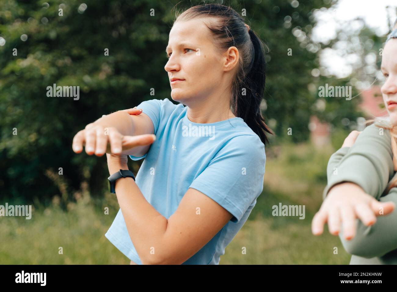 Millennial Woman doing Exercises On nature. Beautiful Athletic teen ...