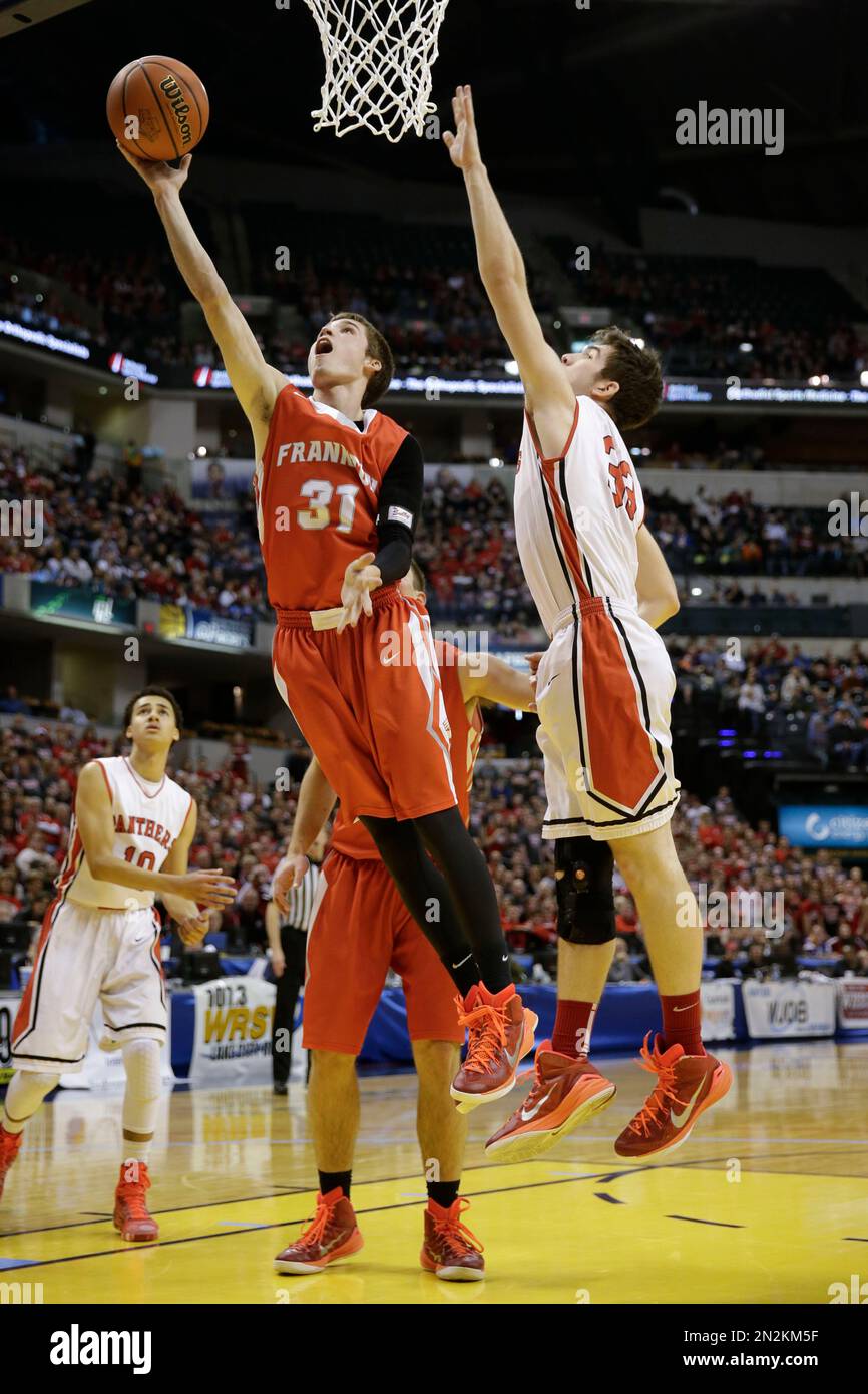 Frankton's Austin Compton, left, shots in front of Park Tudor's Evan Frank during the first half ...
