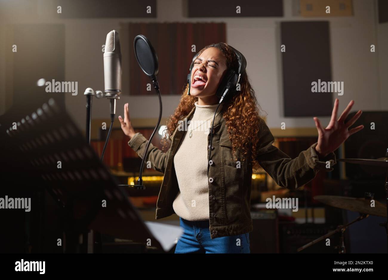 Music, streaming and woman recording in studio in home, singing into ...