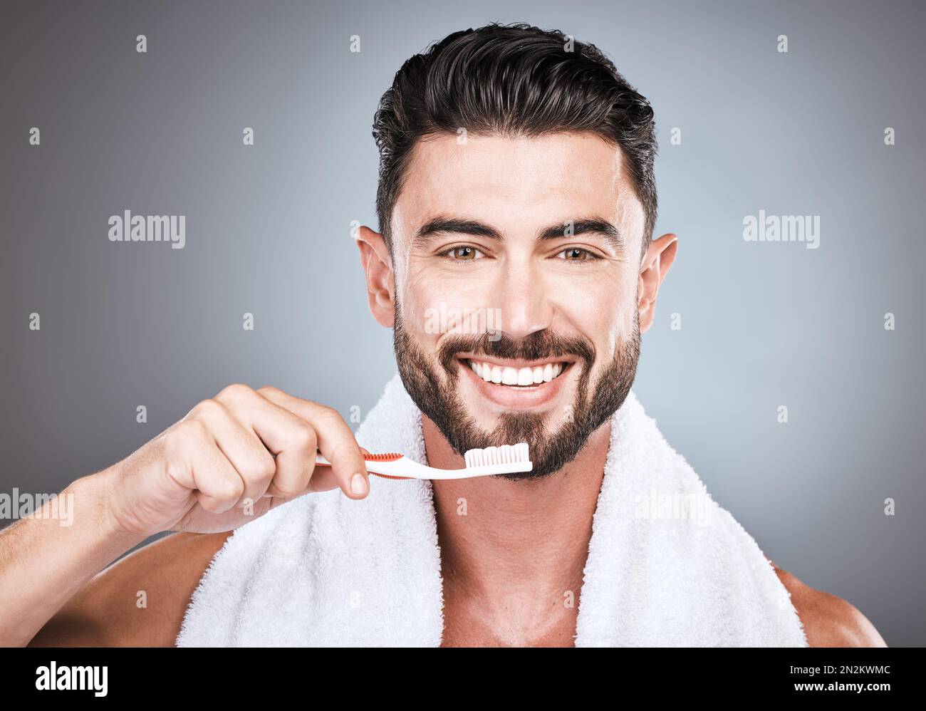 Man, toothbrush and portrait smile for dental care, hygiene or skincare against a gray studio ...