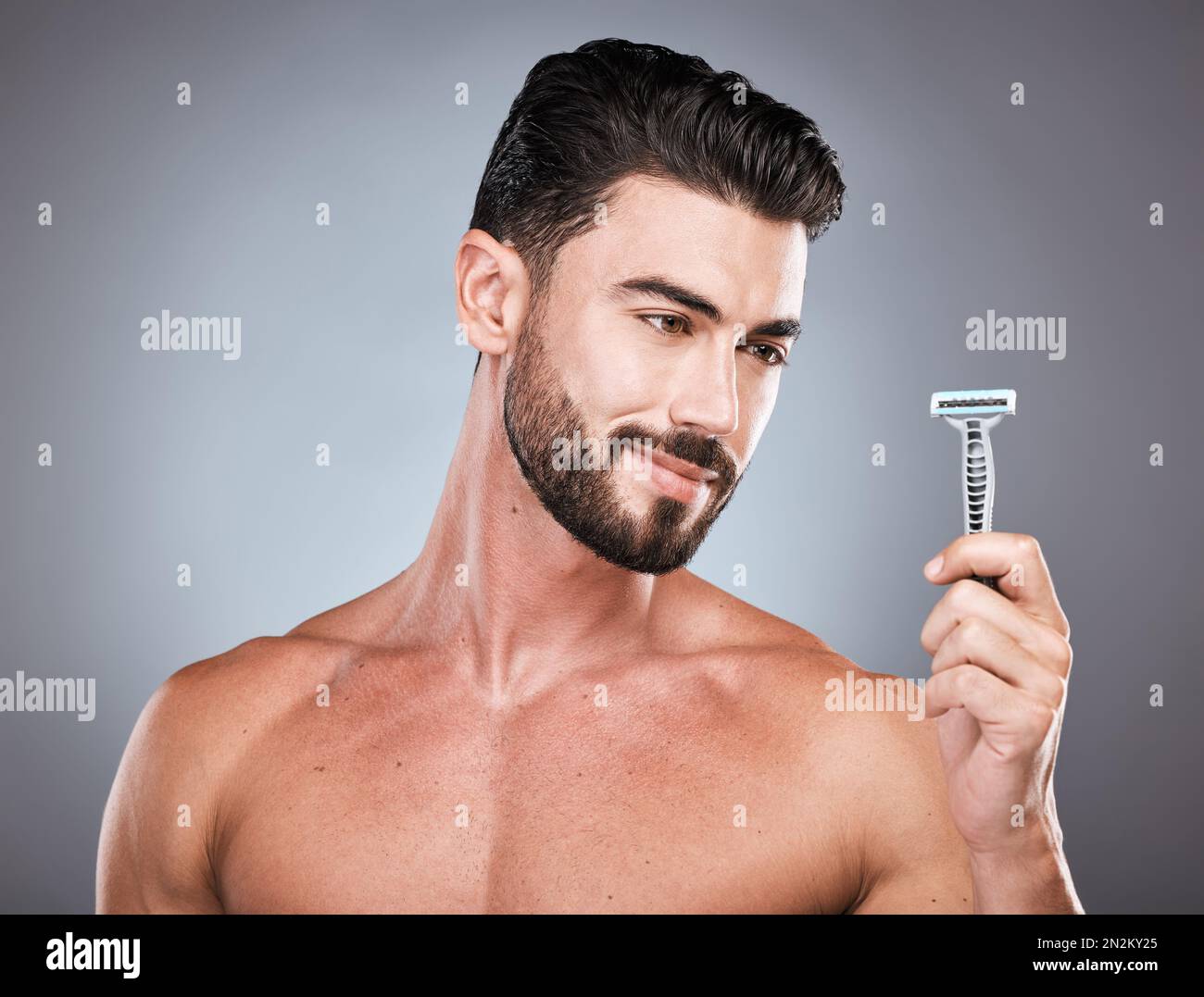 Face, shaving product and man with razor in studio isolated on a gray ...