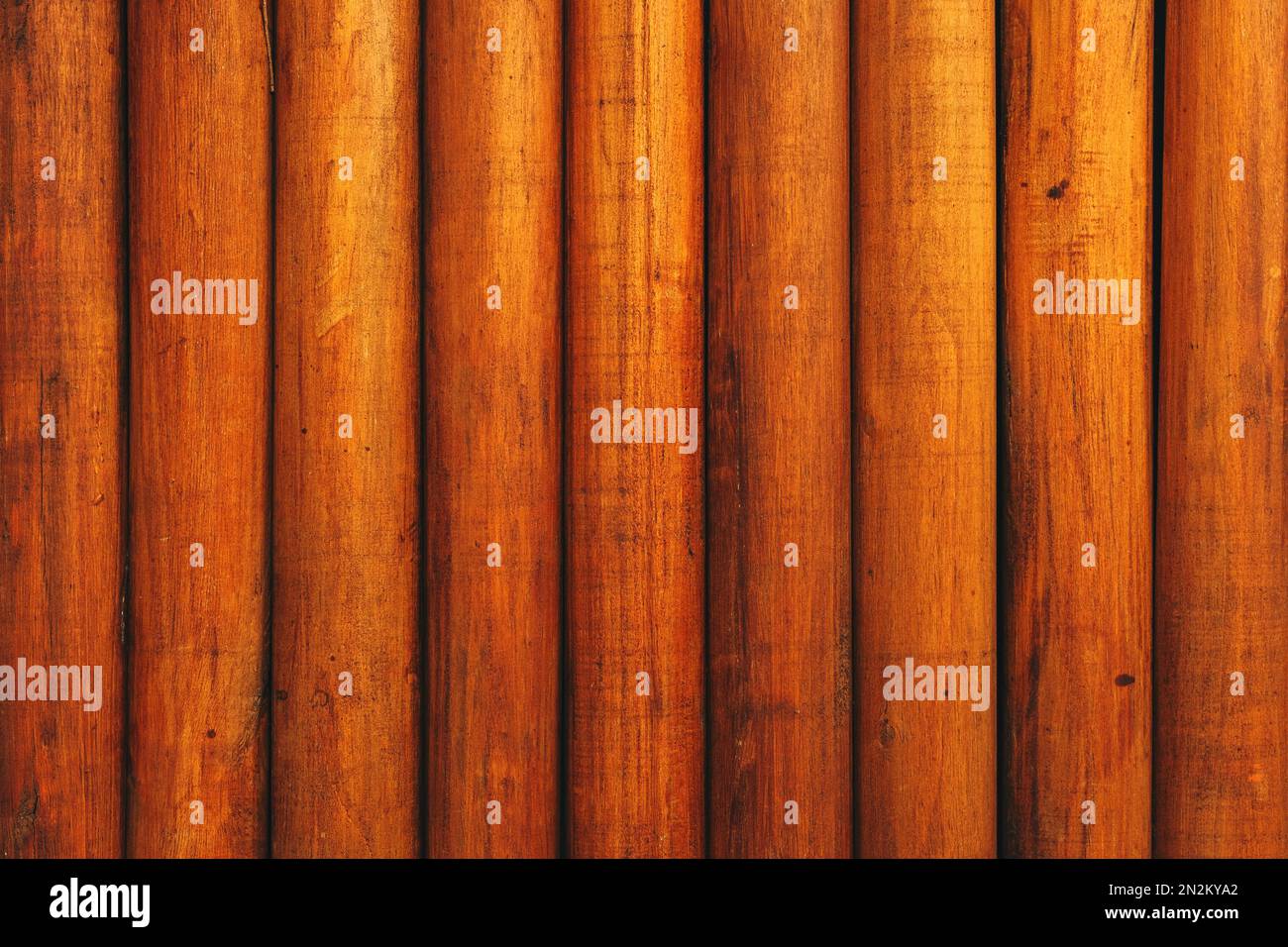 Round timber post wooden fencing as background Stock Photo - Alamy