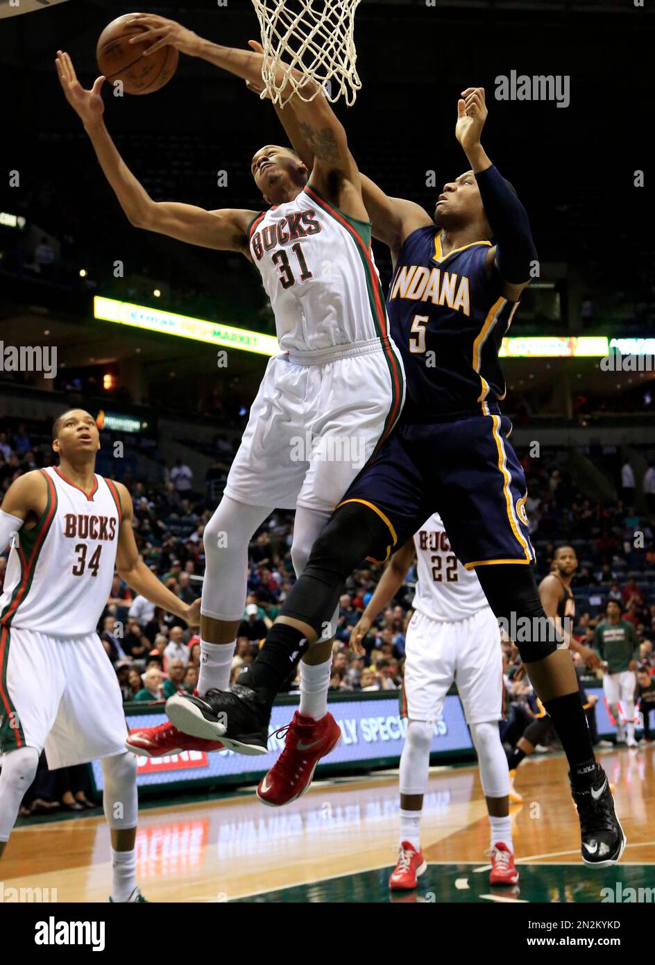 Milwaukee Bucks center John Henson, left, pulls down a rebound from ...