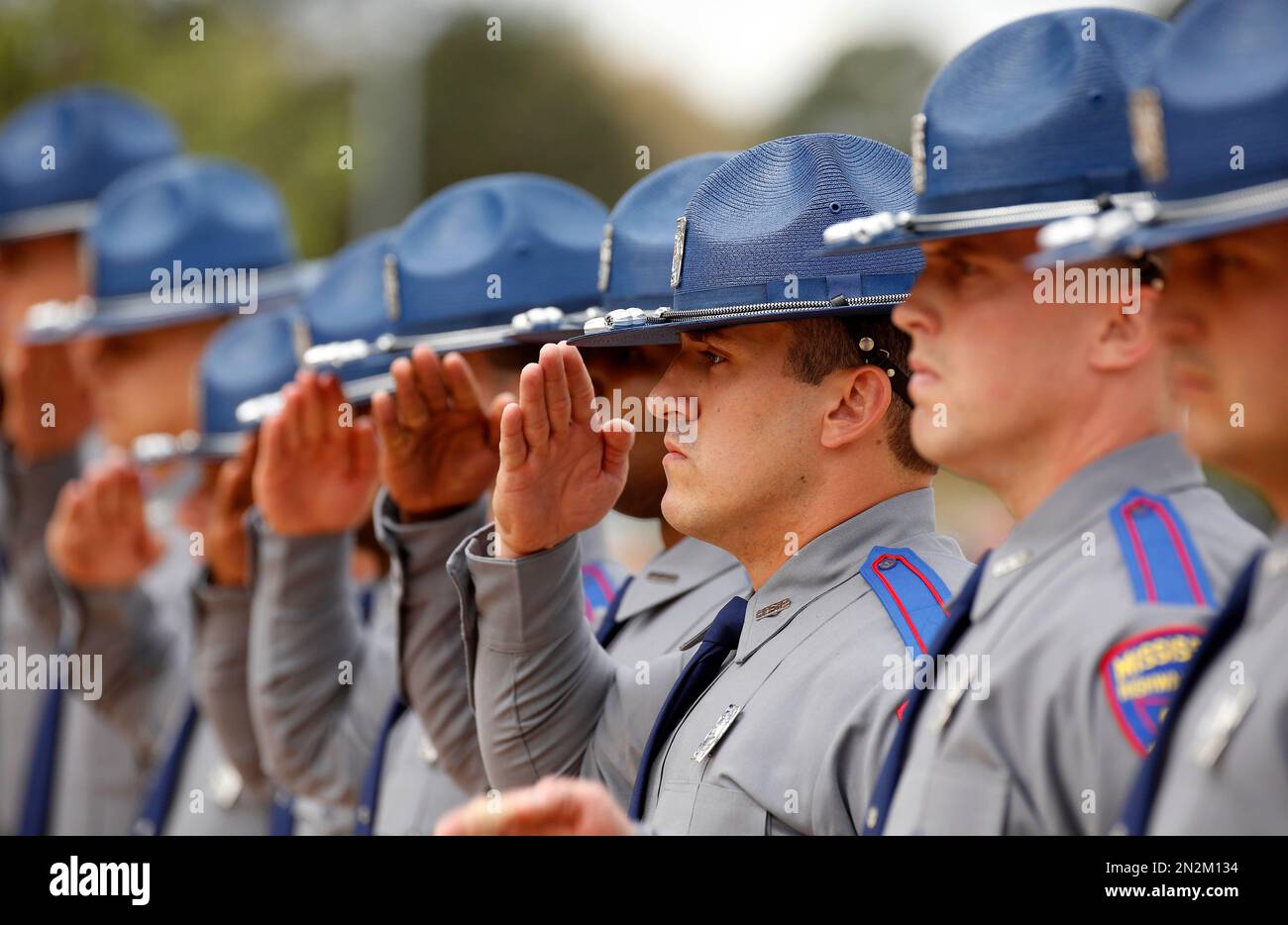 Newly sworn-in troopers perform a saluting drill during the ...