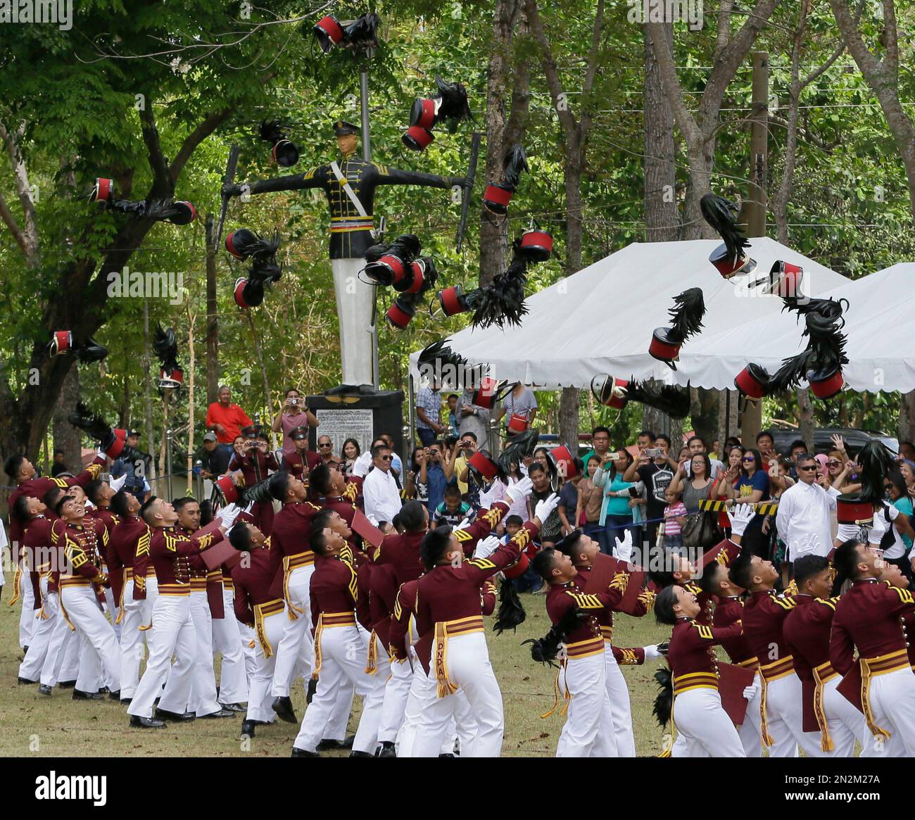 New graduates of the Philippine National Police Academy toss their caps ...