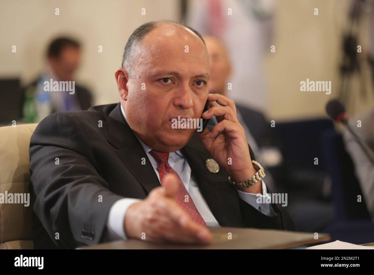 Egyptian Foreign Minister Sameh Shukri speaks on the phone during a ...