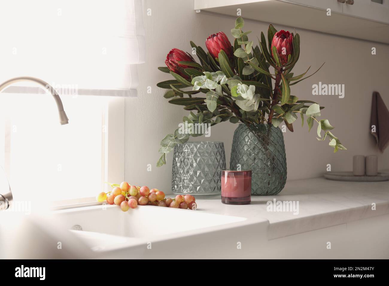 Bouquet with beautiful protea flowers on countertop in kitchen ...