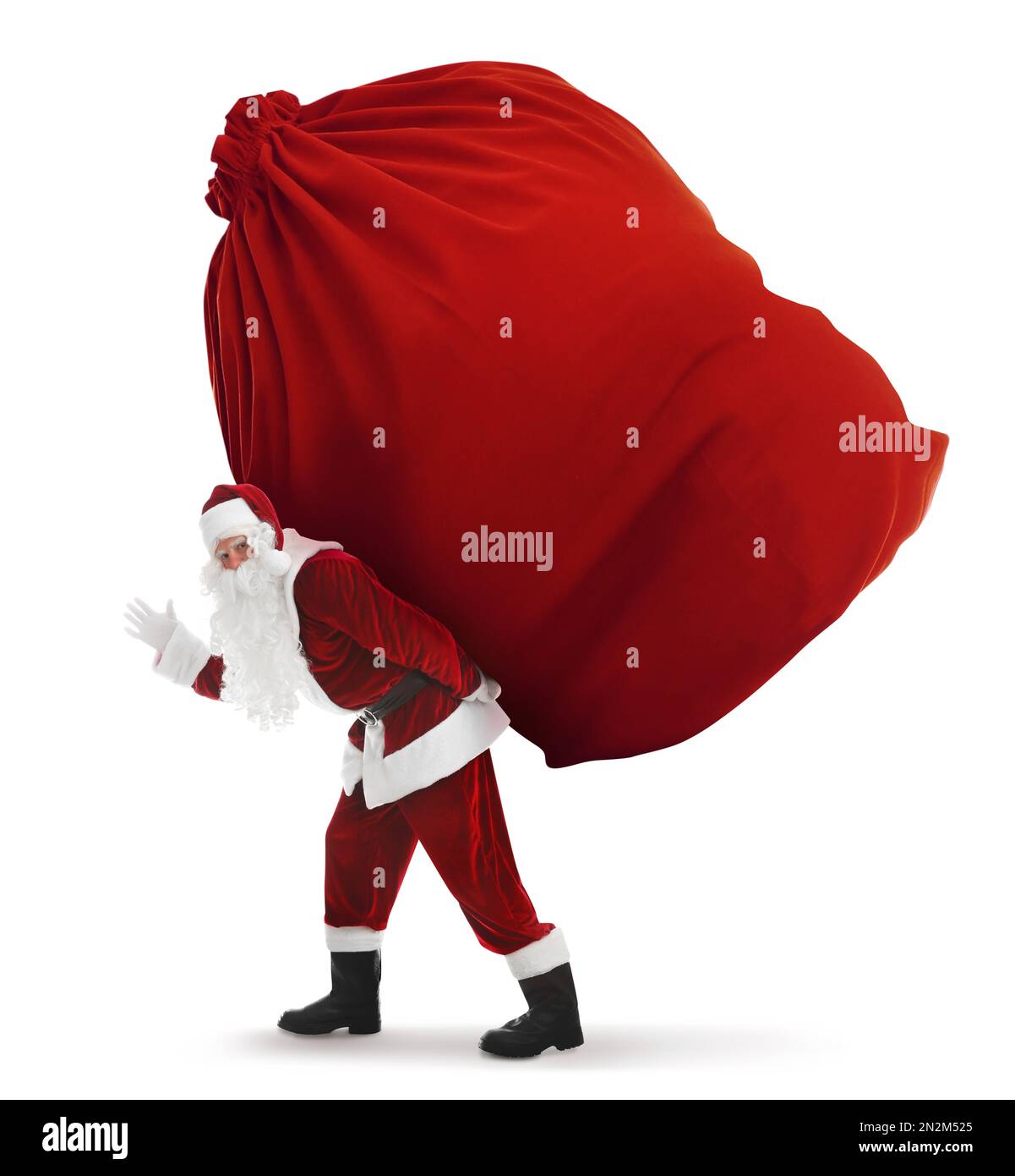 Santa Claus carrying enormous red bag full of Christmas gifts on white ...