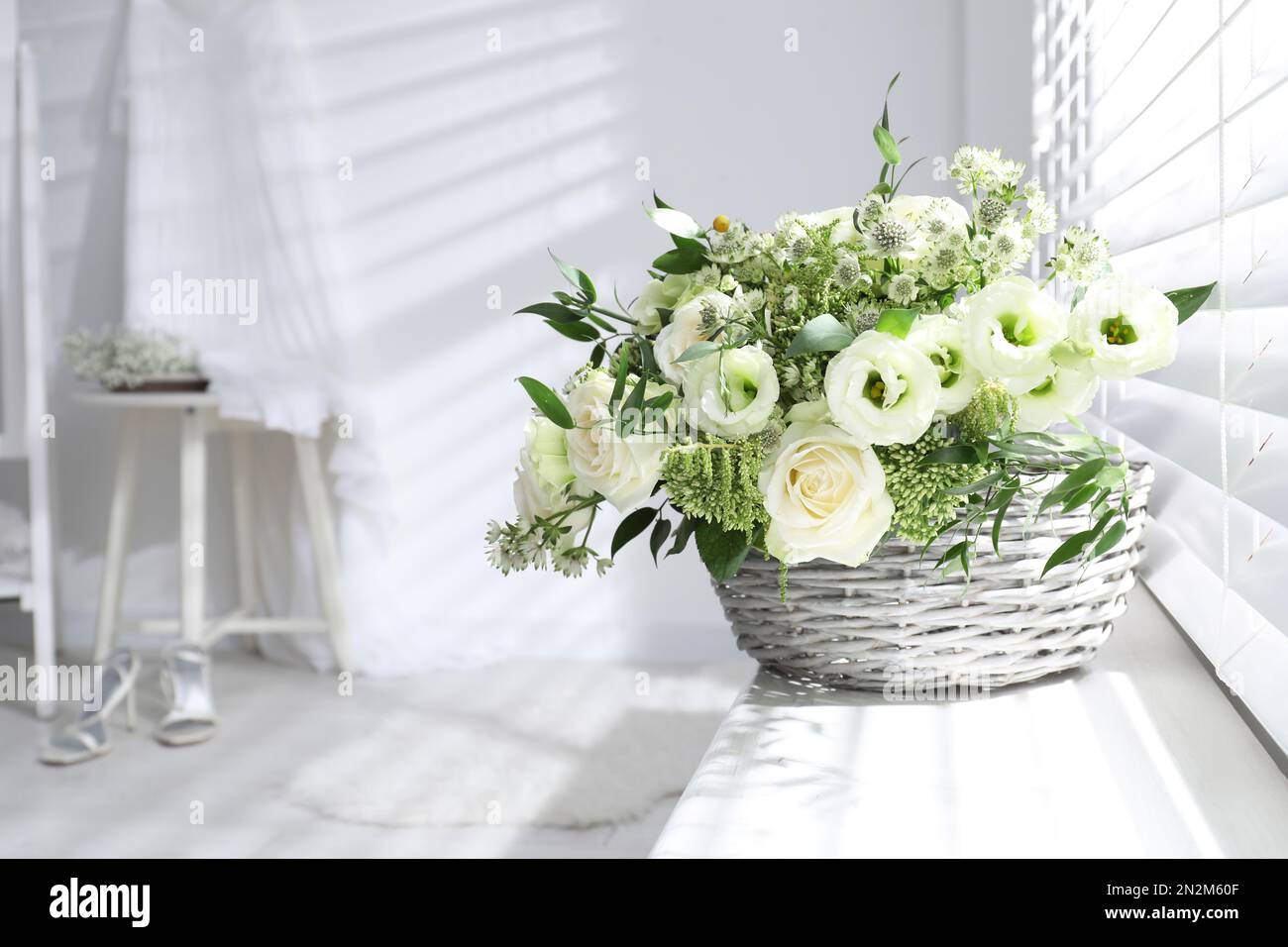 Basket with beautiful wedding flowers on window sill in room Stock ...