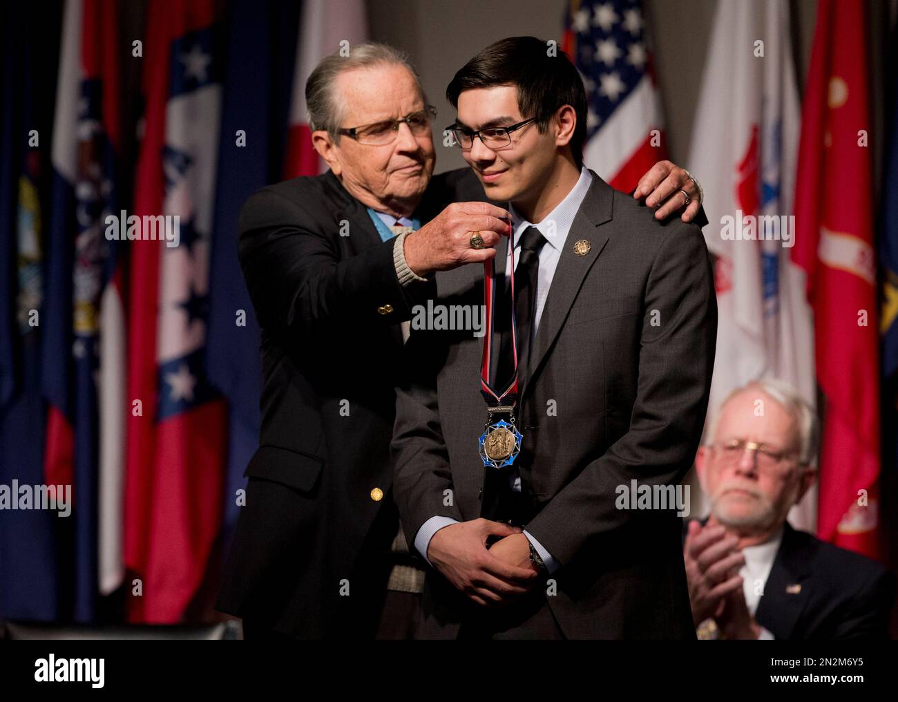 Jon Meis of Renton, Wash., right, is presented by Medal of Honor ...