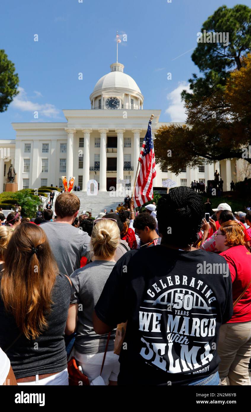 People gather at the steps of the Alabama State Capitol after a march ...