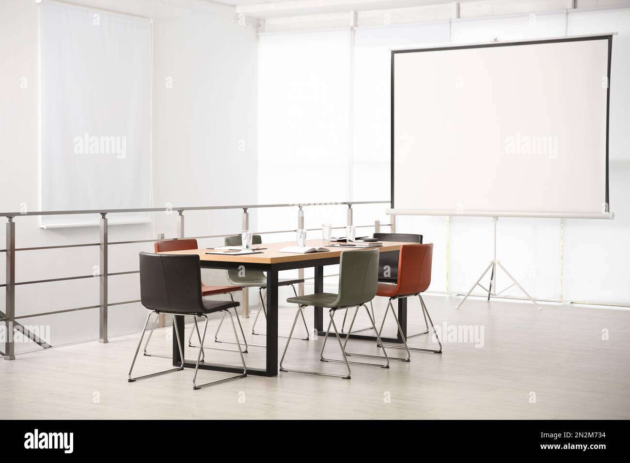 Modern meeting room interior with large table and projection screen ...