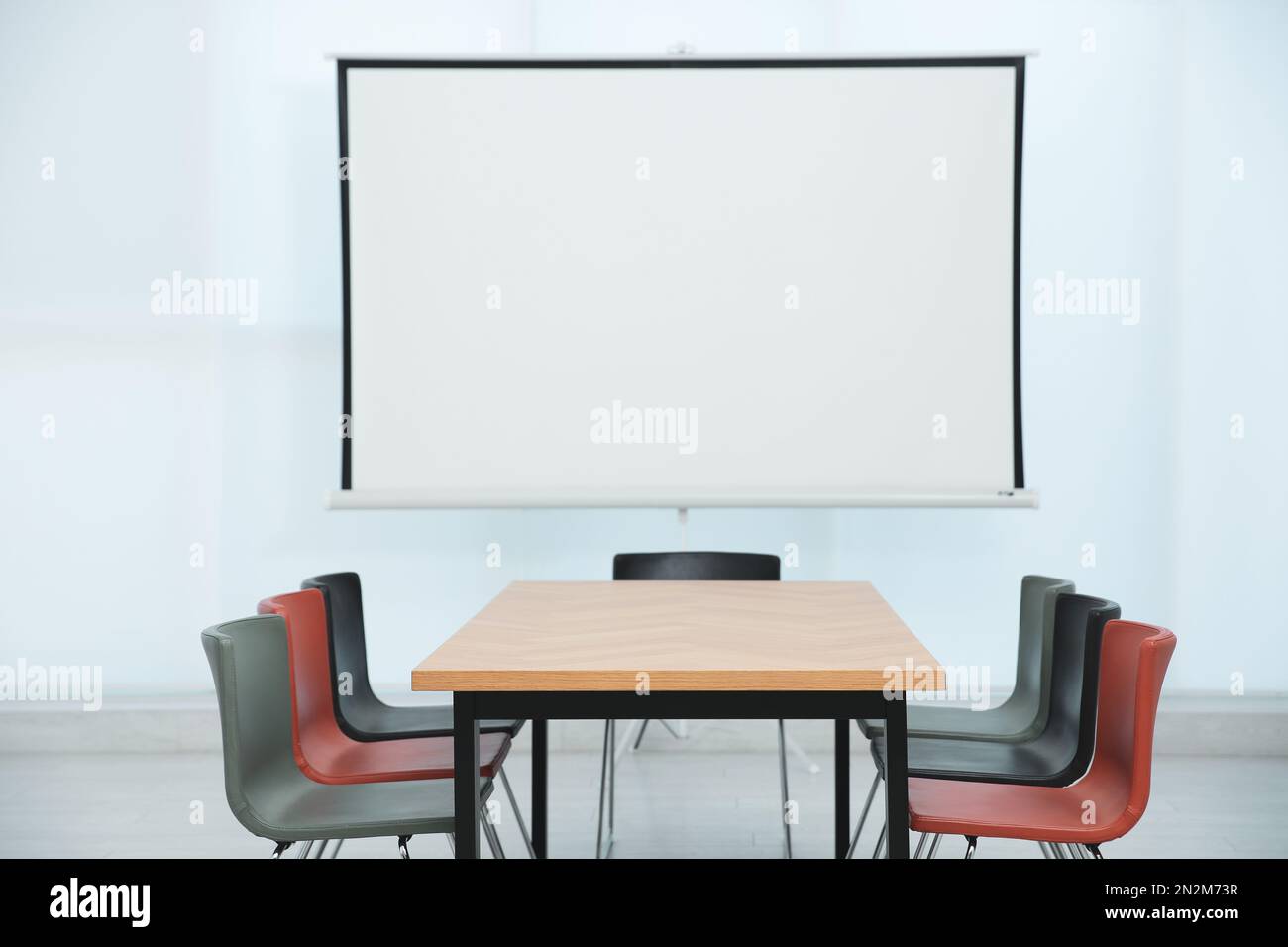 Conference room interior with wooden table and video projection screen ...