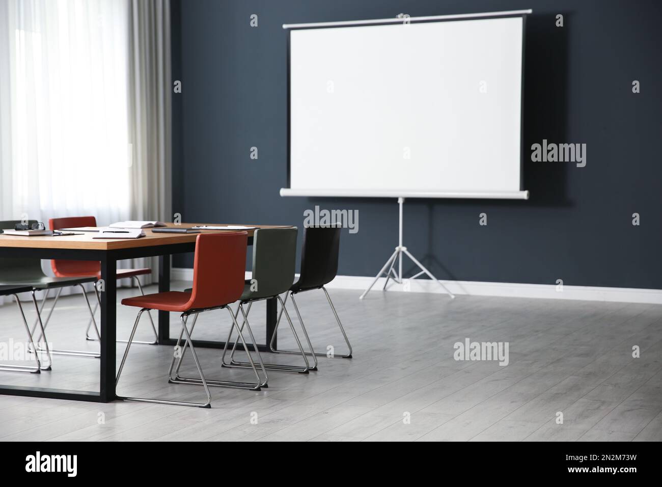 Modern meeting room interior with large table and projection screen ...