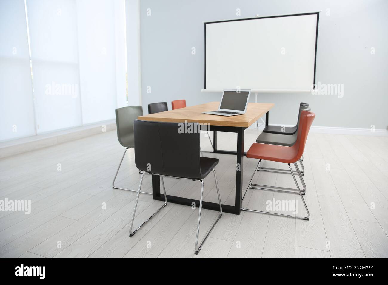 Conference room interior with wooden table and video projection screen ...