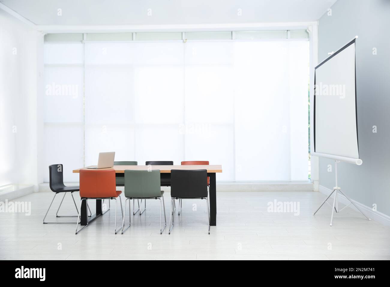 Conference room interior with wooden table and video projection screen ...